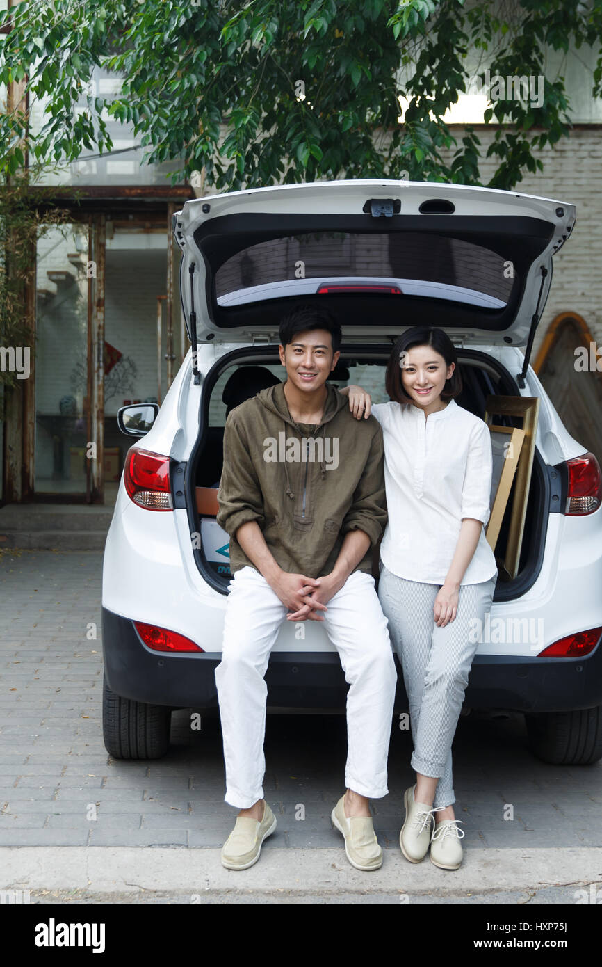 Young couple sitting in back of car Stock Photo - Alamy