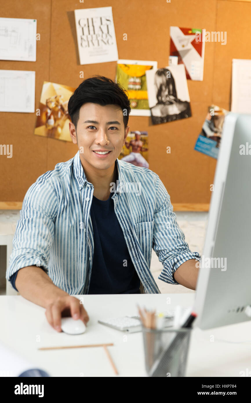 Young man using computer at home Stock Photo - Alamy