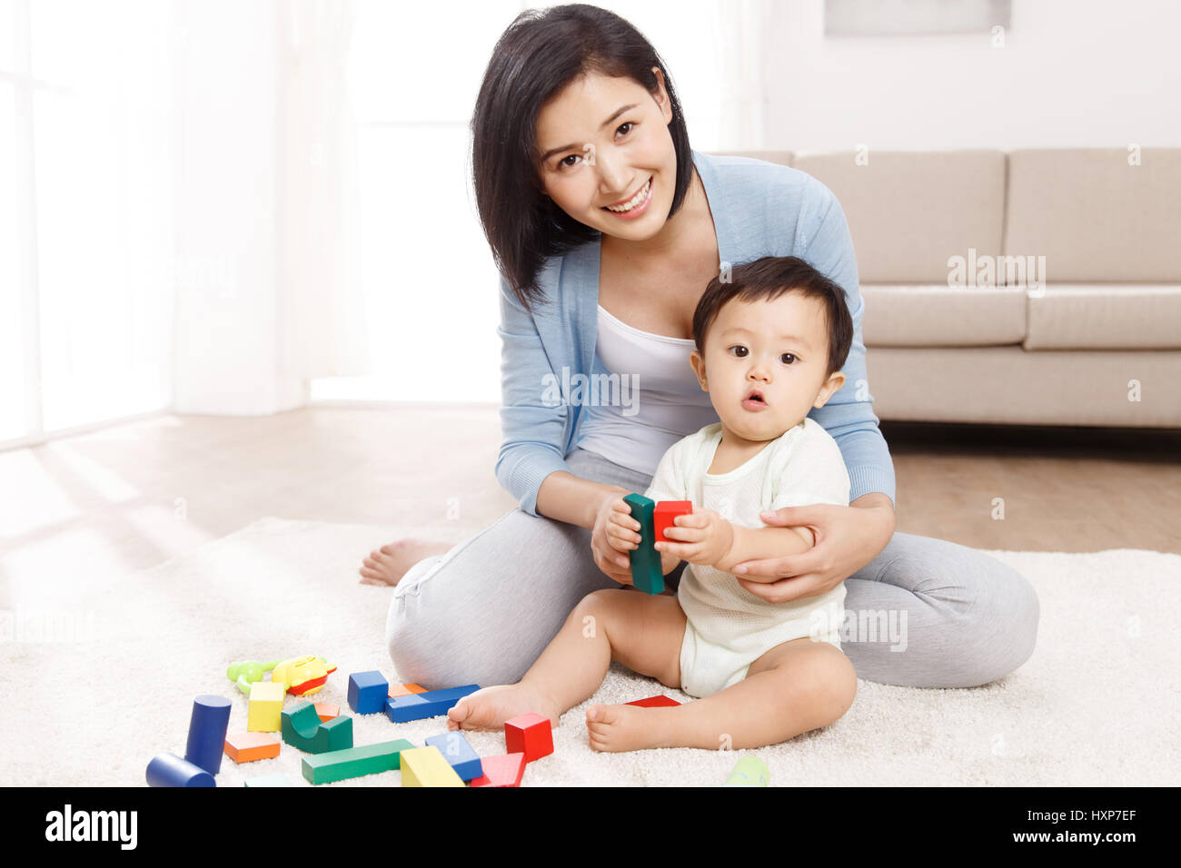 Mother playing with her baby Stock Photo - Alamy