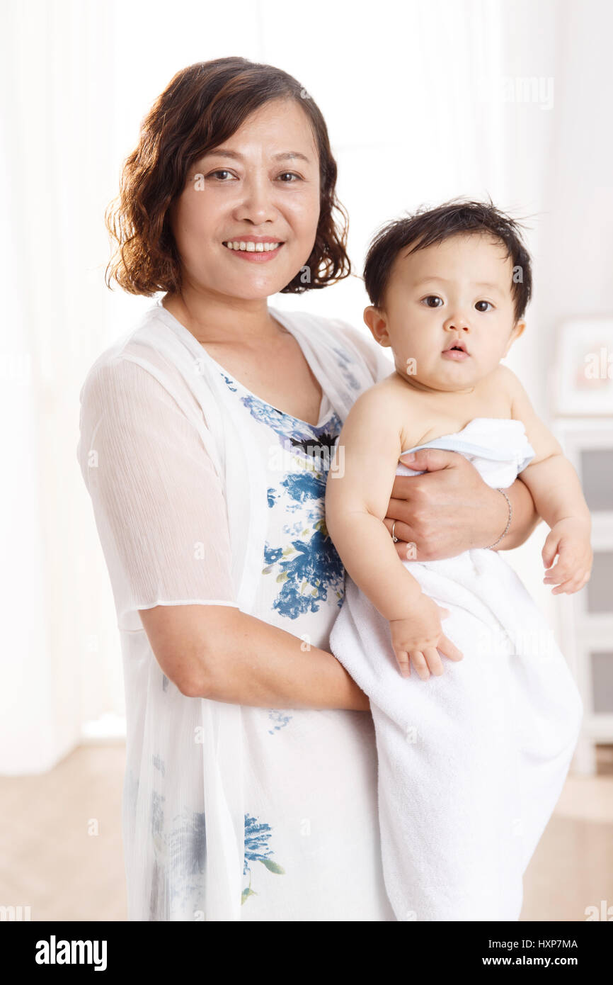 Grandmother carrying baby boy Stock Photo - Alamy