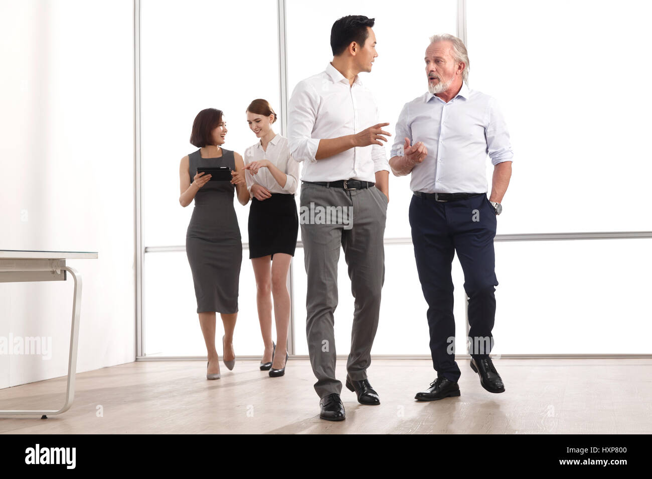 Four business people in discussion Stock Photo - Alamy