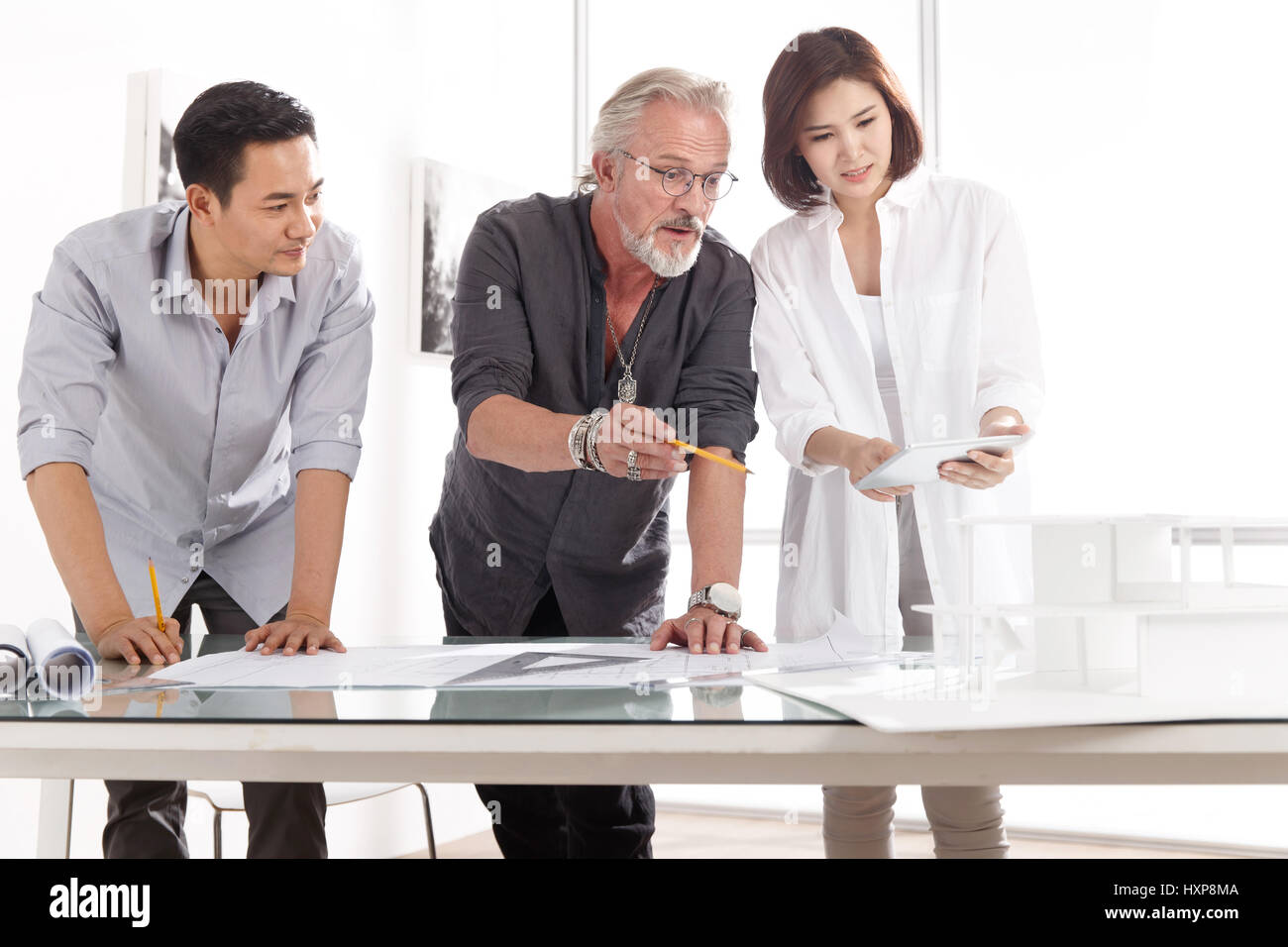 Architects working on blueprint Stock Photo - Alamy