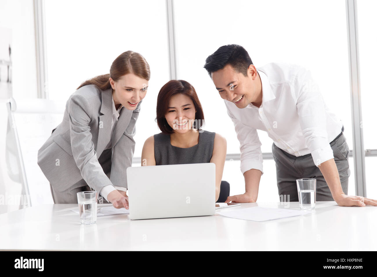 Three business people in office Stock Photo - Alamy