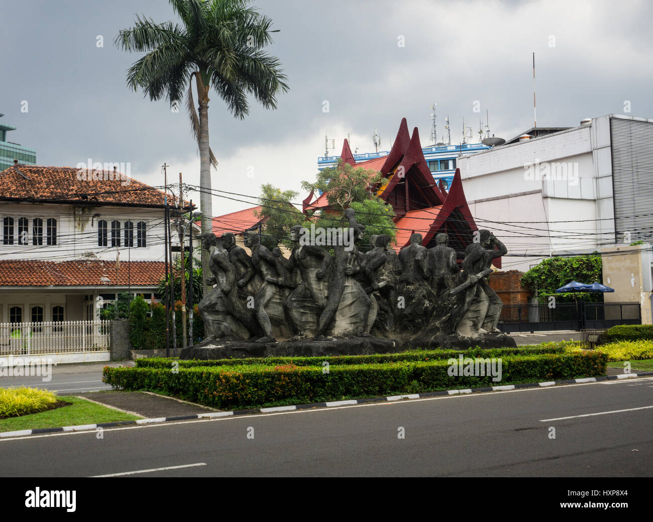 A great statue monument made from copper shows a group of people in one ...