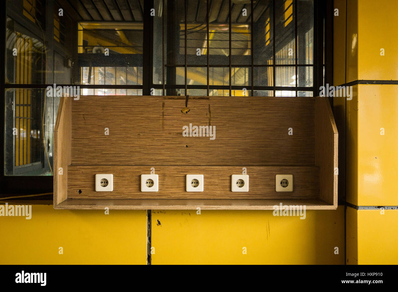 electric socket on wooden wall at charging facility in train station ...