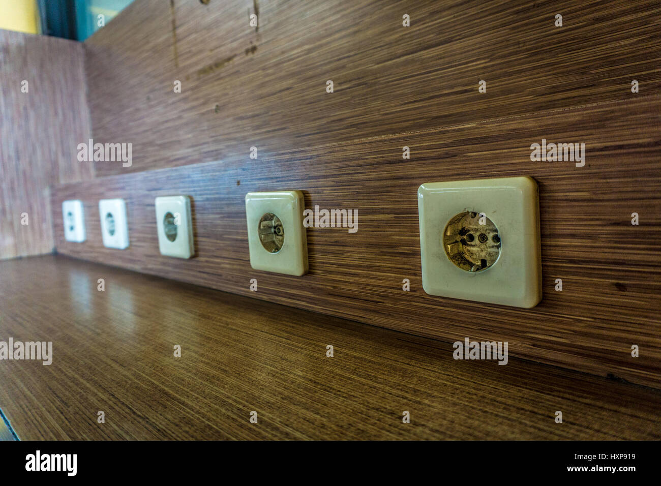 electric socket on wooden wall at charging facility in public area ...