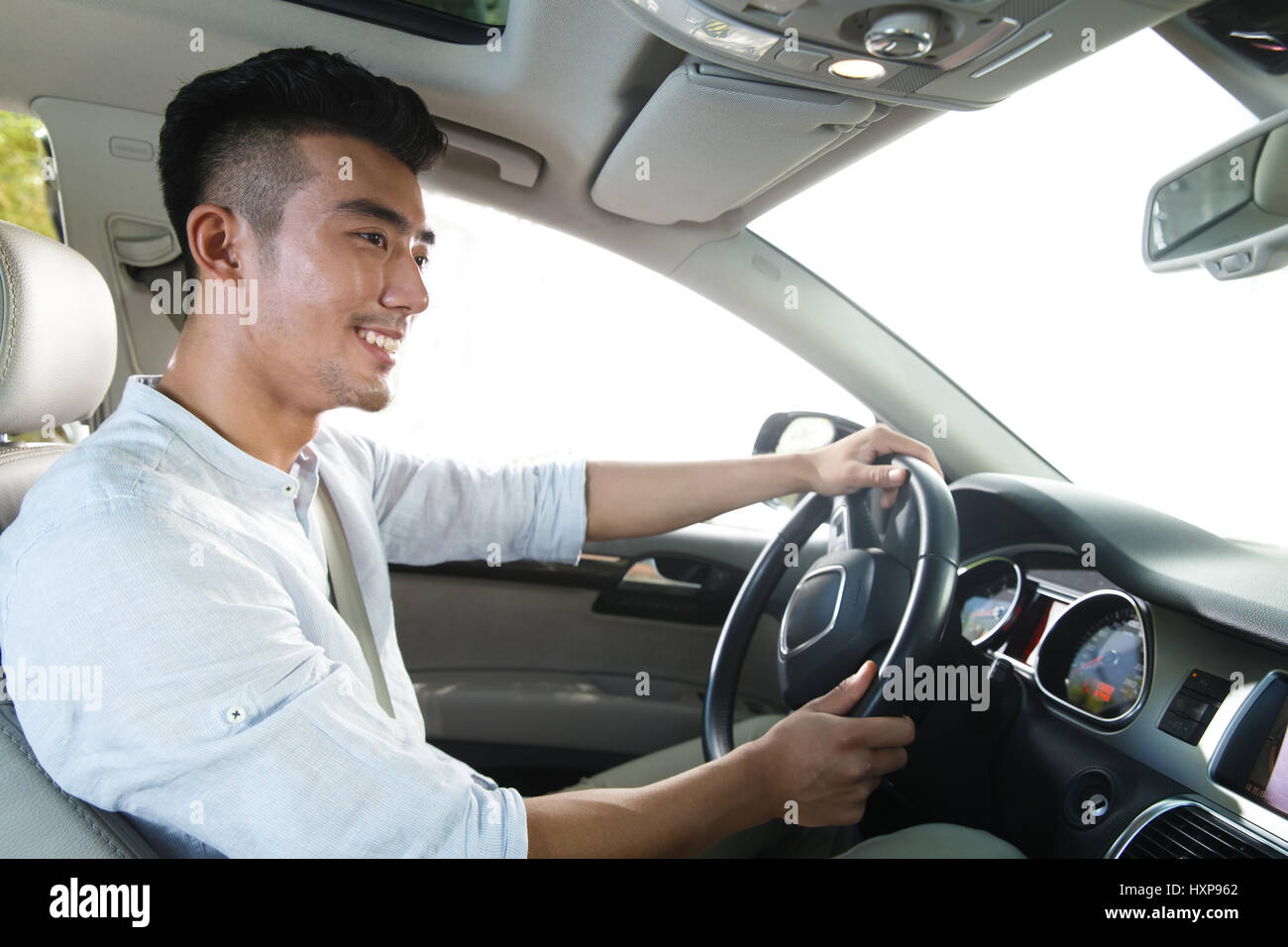 Young man driving a car Stock Photo - Alamy