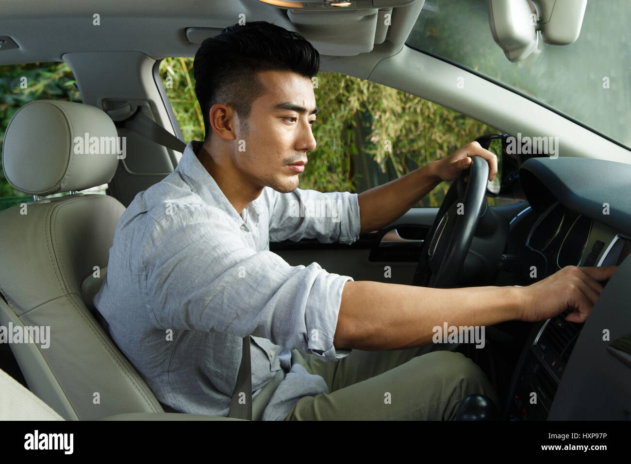 Young man driving and using GPS system in car Stock Photo - Alamy
