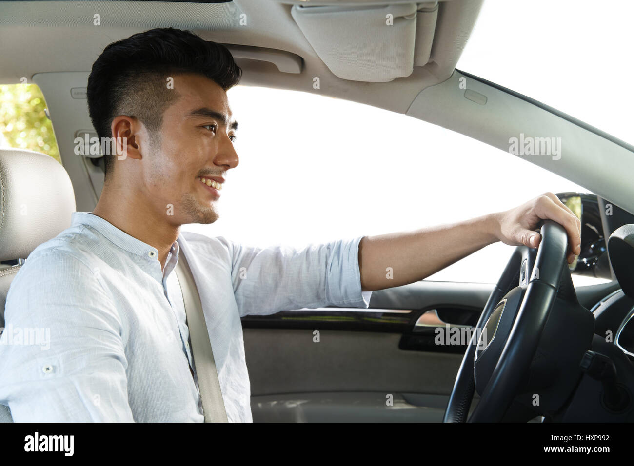 Young man driving a car Stock Photo - Alamy