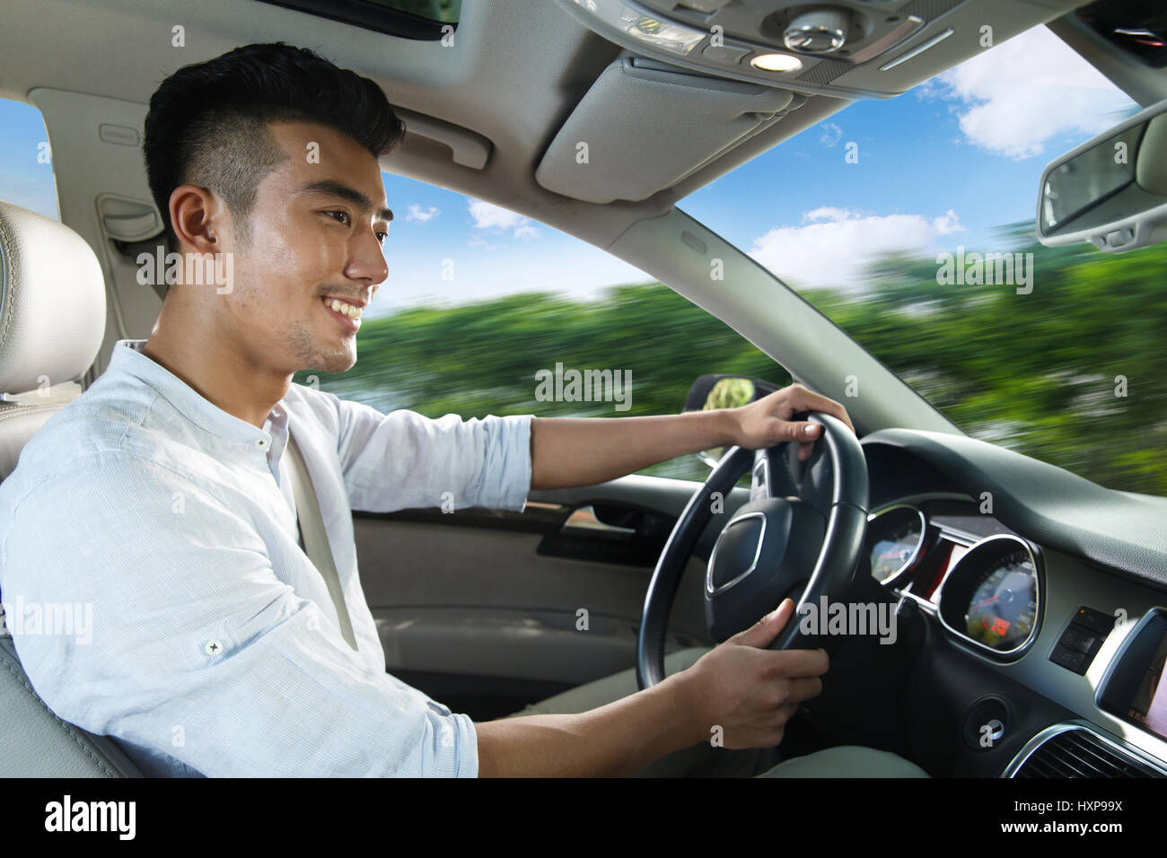 Young man driving a car Stock Photo - Alamy