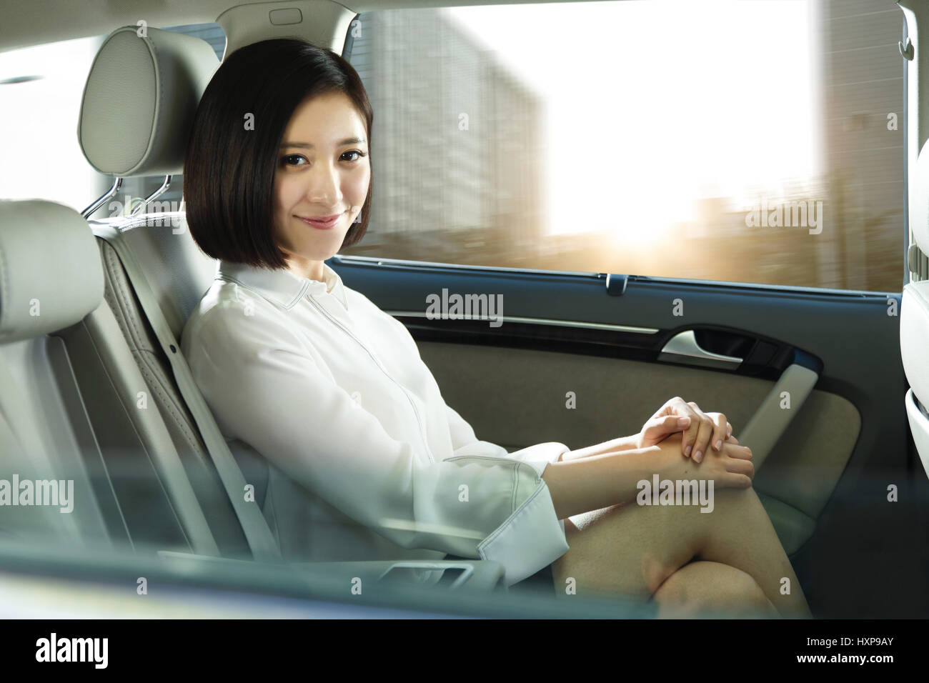 Young woman sitting in car Stock Photo - Alamy