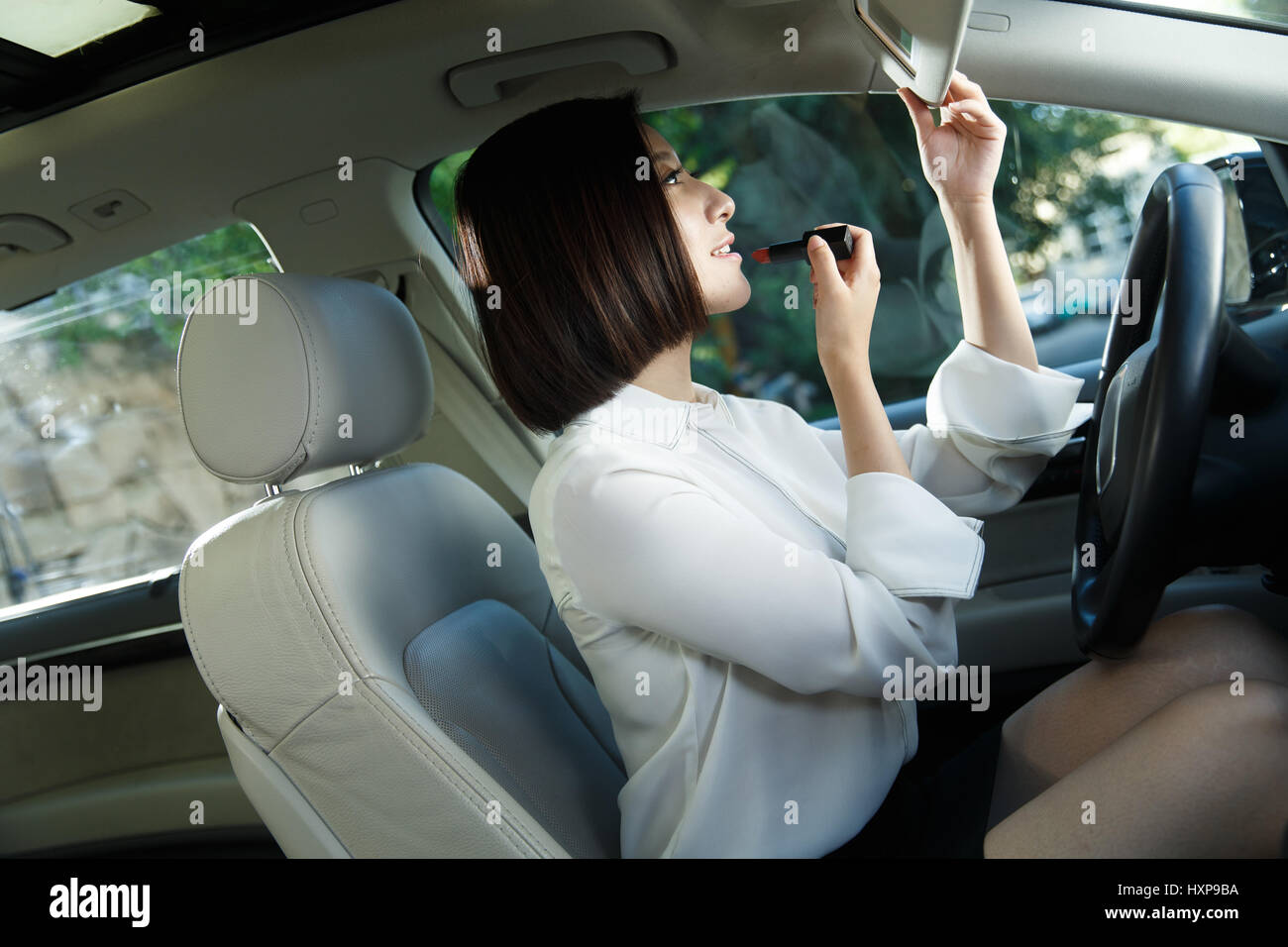 Young woman make up in car Stock Photo - Alamy
