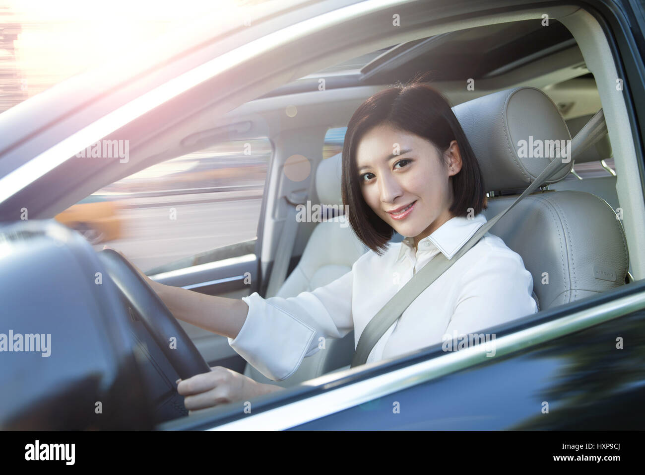 Young woman driving car Stock Photo - Alamy