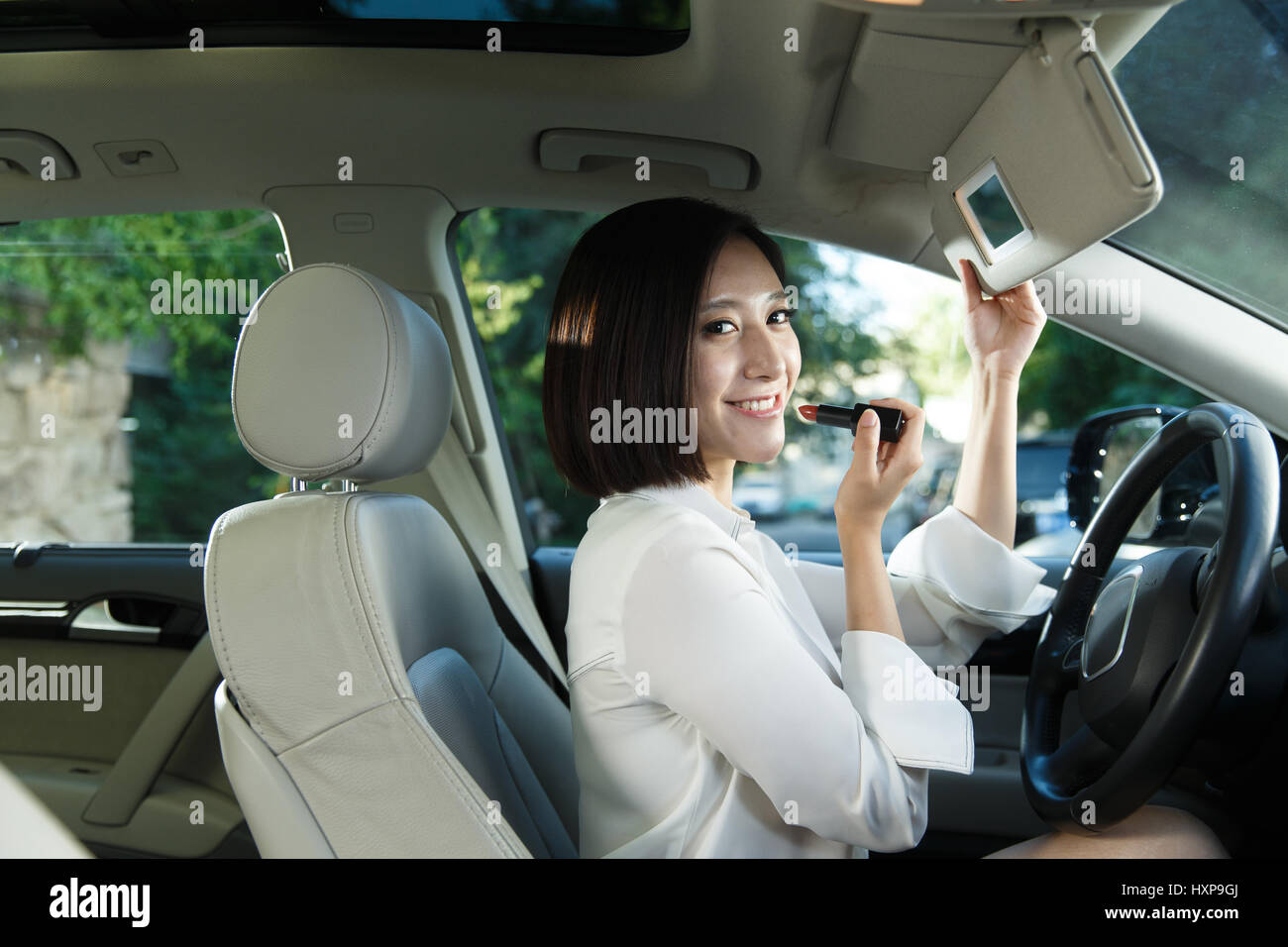 Young woman make up in car Stock Photo - Alamy