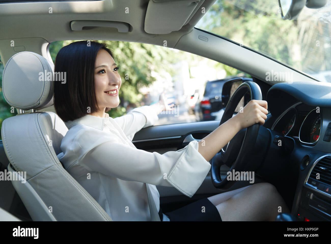 Young woman driving car Stock Photo - Alamy
