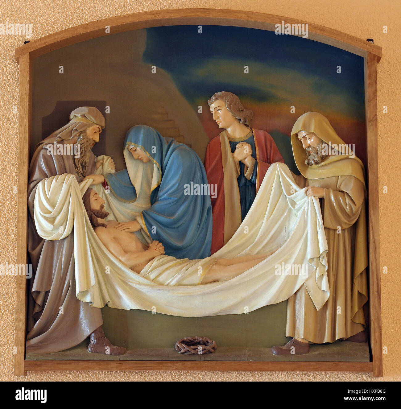 14th Stations of the Cross, Jesus is laid in the tomb and covered in ...