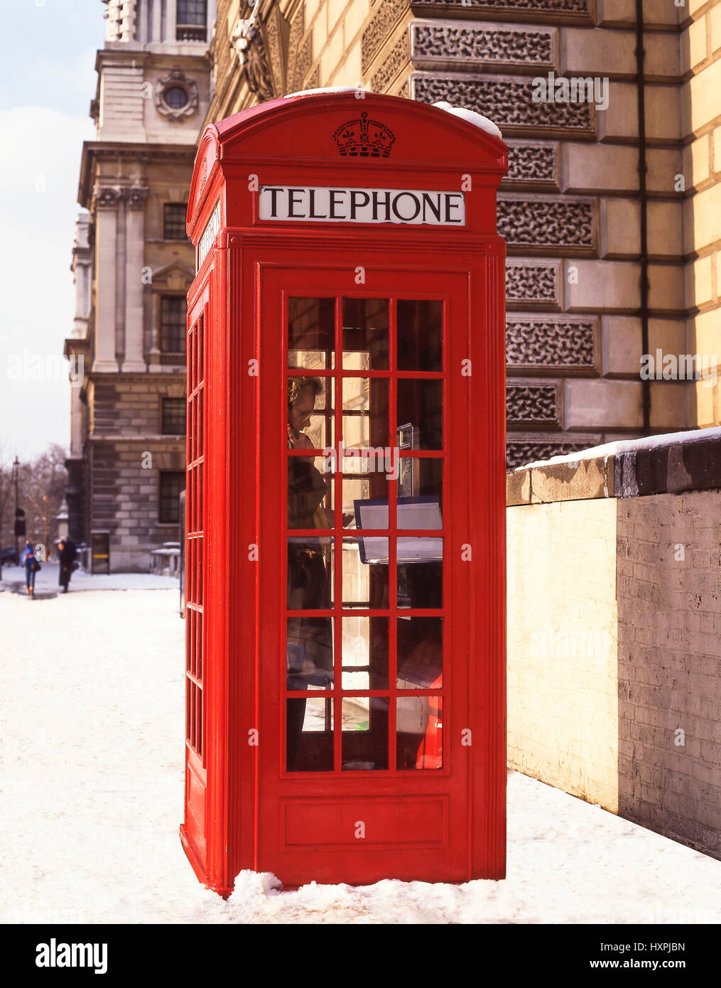 Traditional red phone kiosk in winter snow, Parliament Square, City of ...