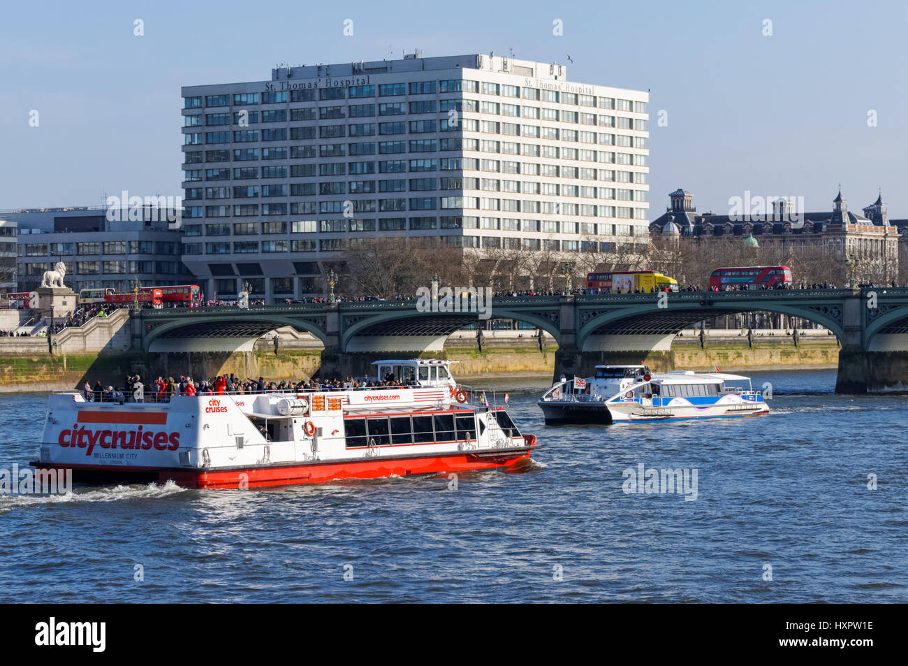 Cruise boats on the River Thames with St Thomas' Hospital in the ...
