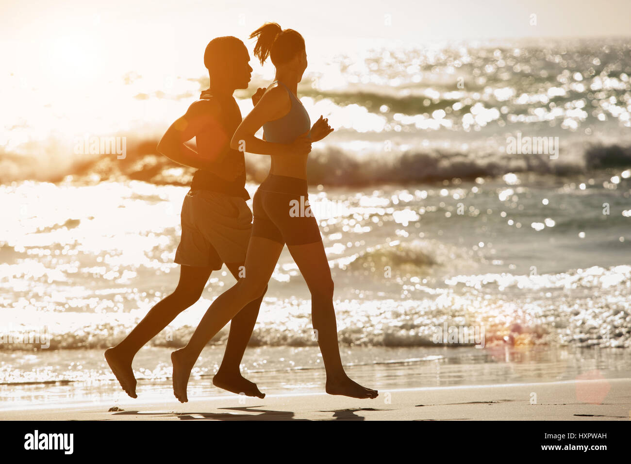 Silhouette man woman jogging beach hi-res stock photography and images ...