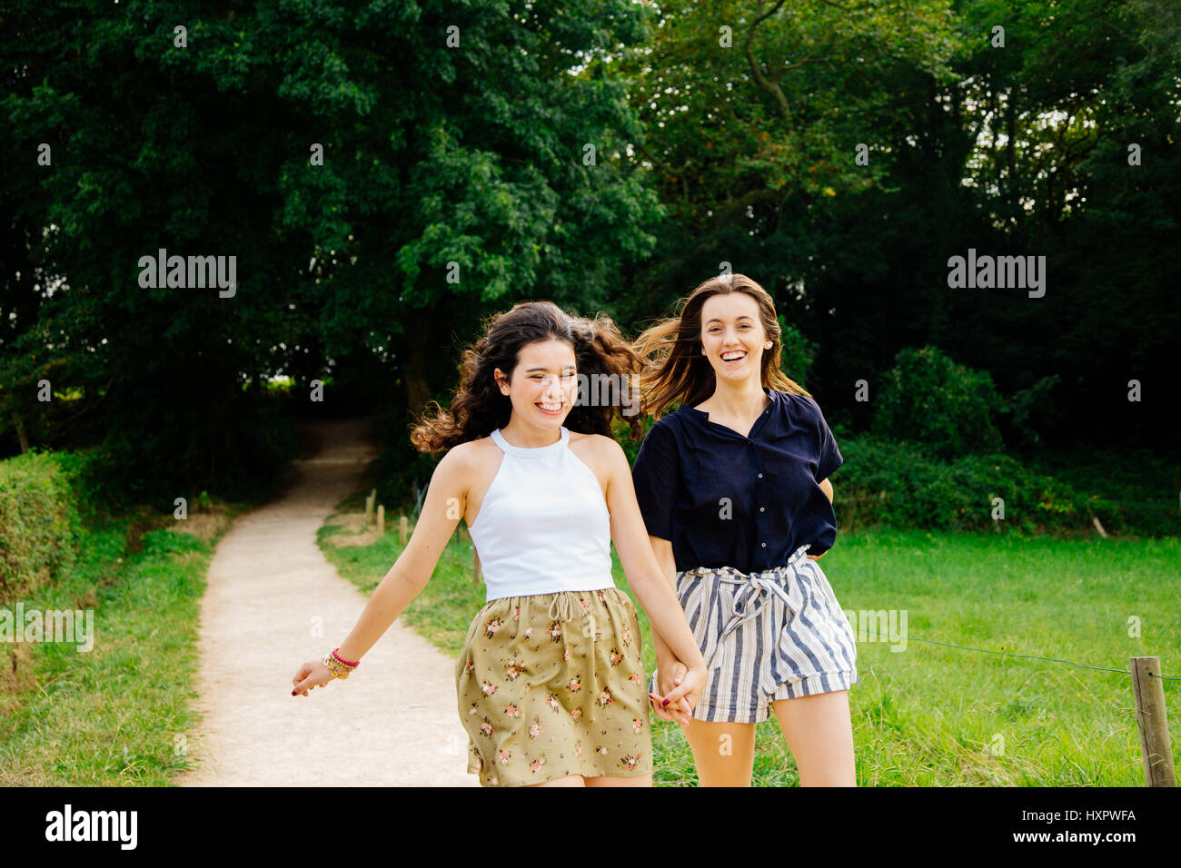 Two best friends holding hands hi-res stock photography and images - Alamy