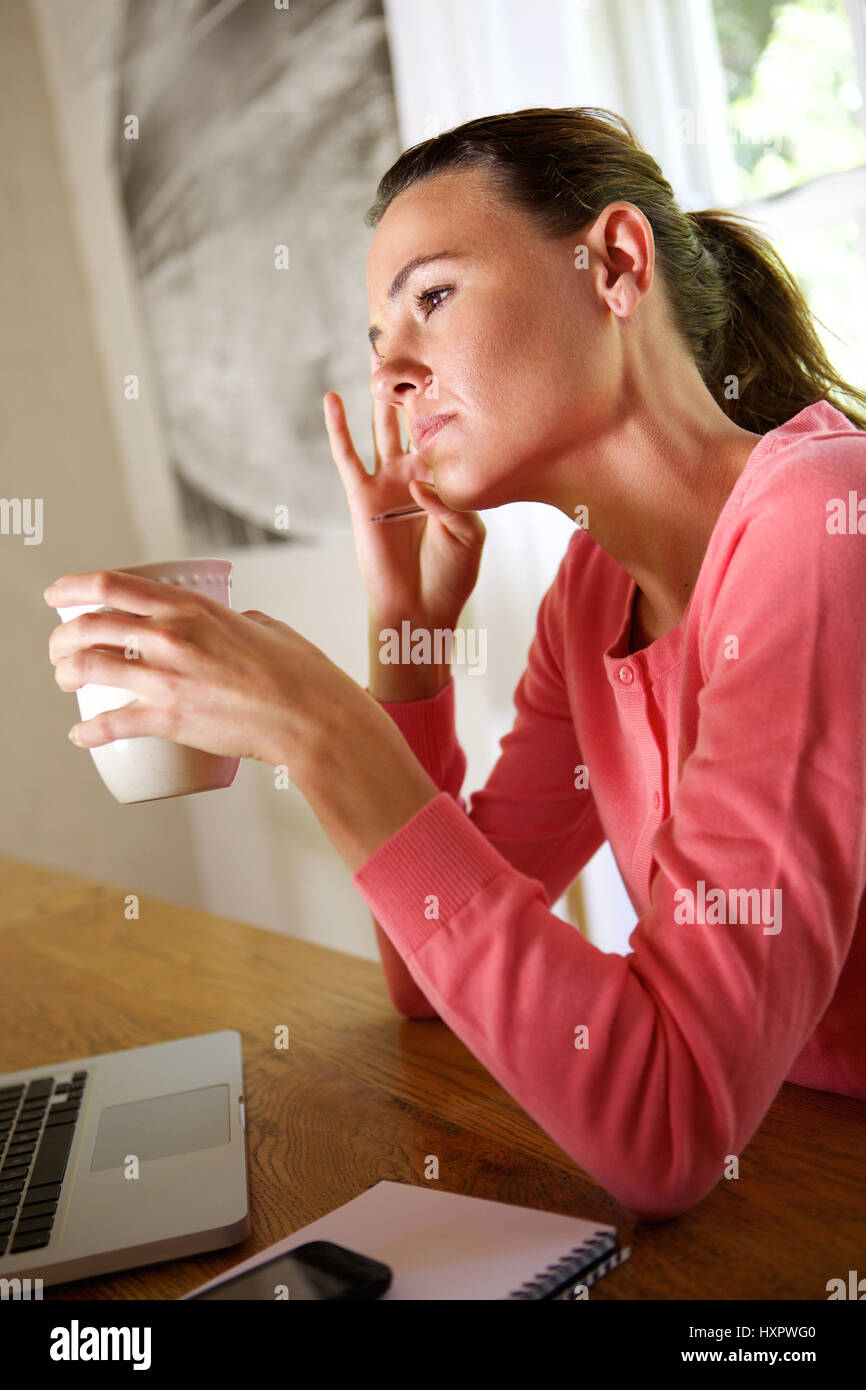Pensive young woman thinking working hi-res stock photography and ...