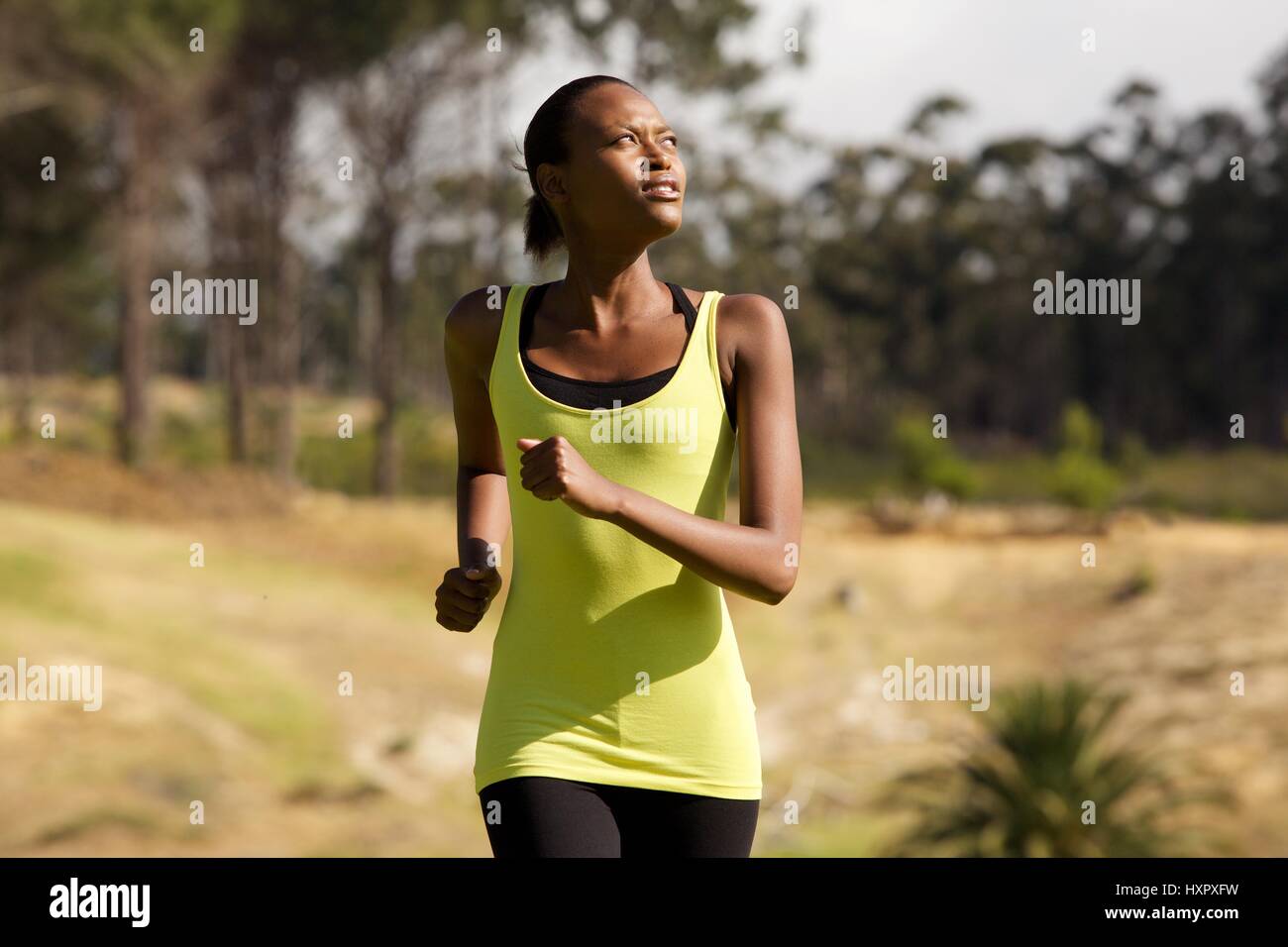 Portrait of a healthy young african woman running outdoors Stock Photo ...