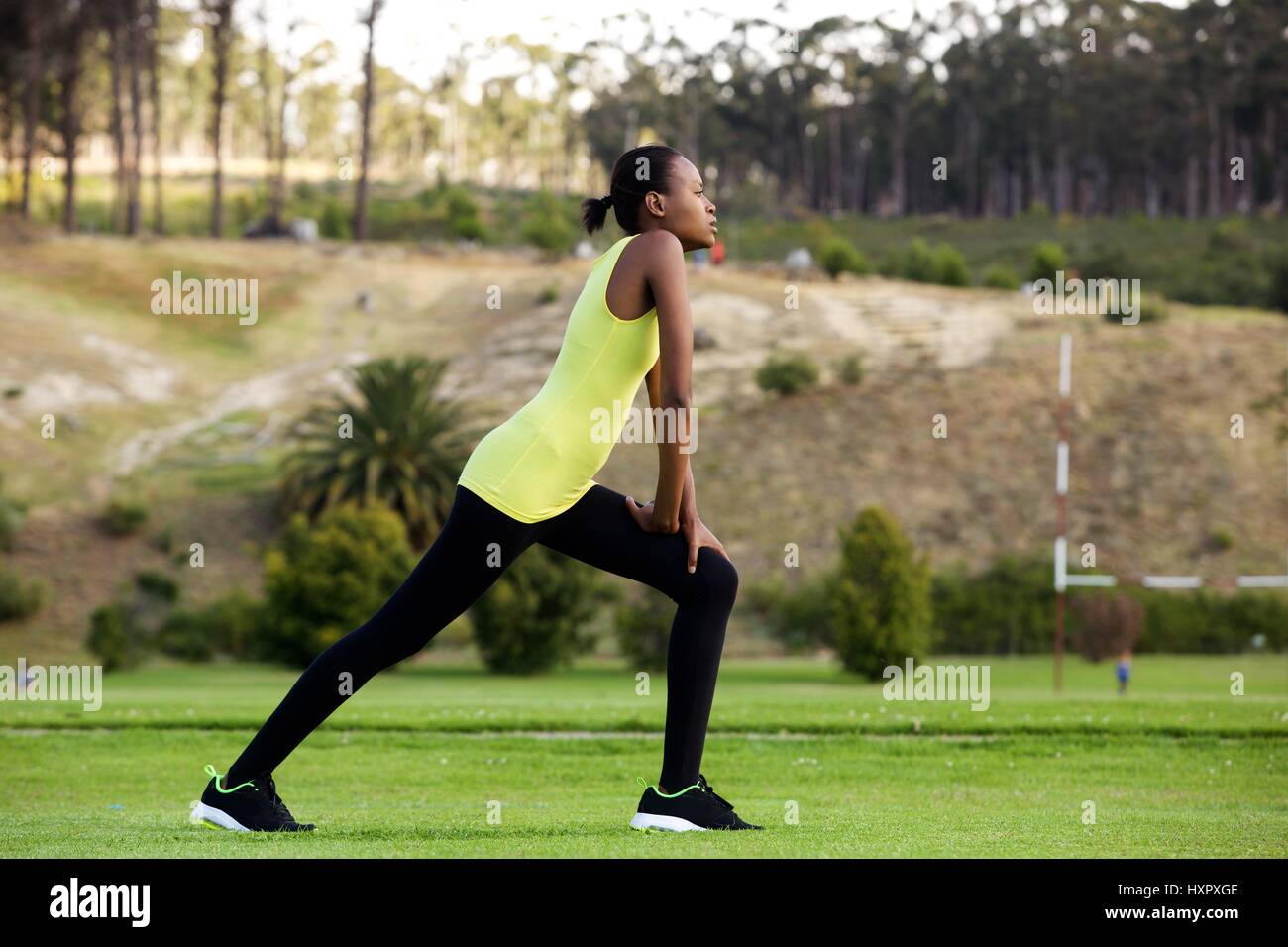 Full body portrait of african woman doing stretching workout in the ...