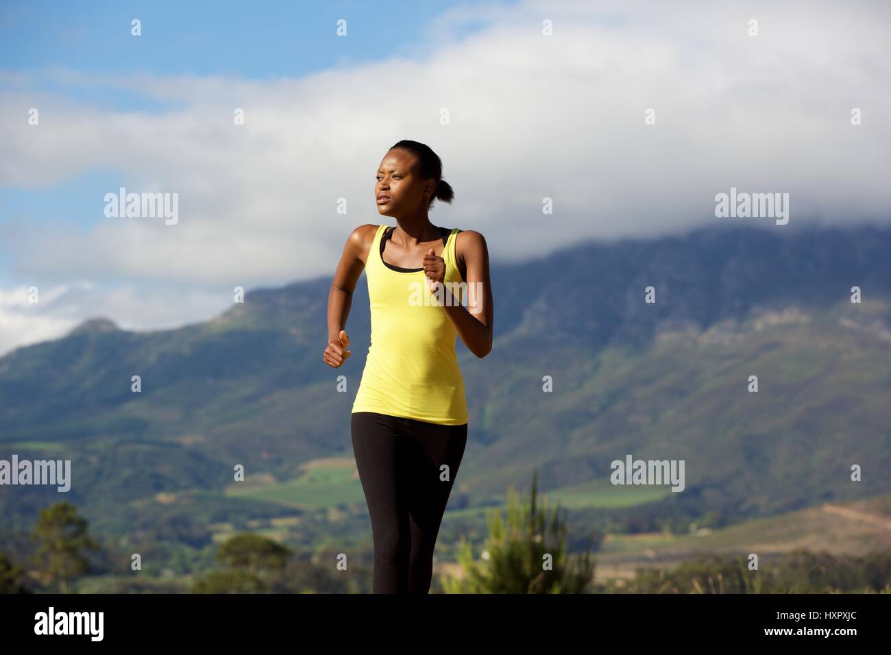 Portrait of fit young black woman running in nature Stock Photo - Alamy