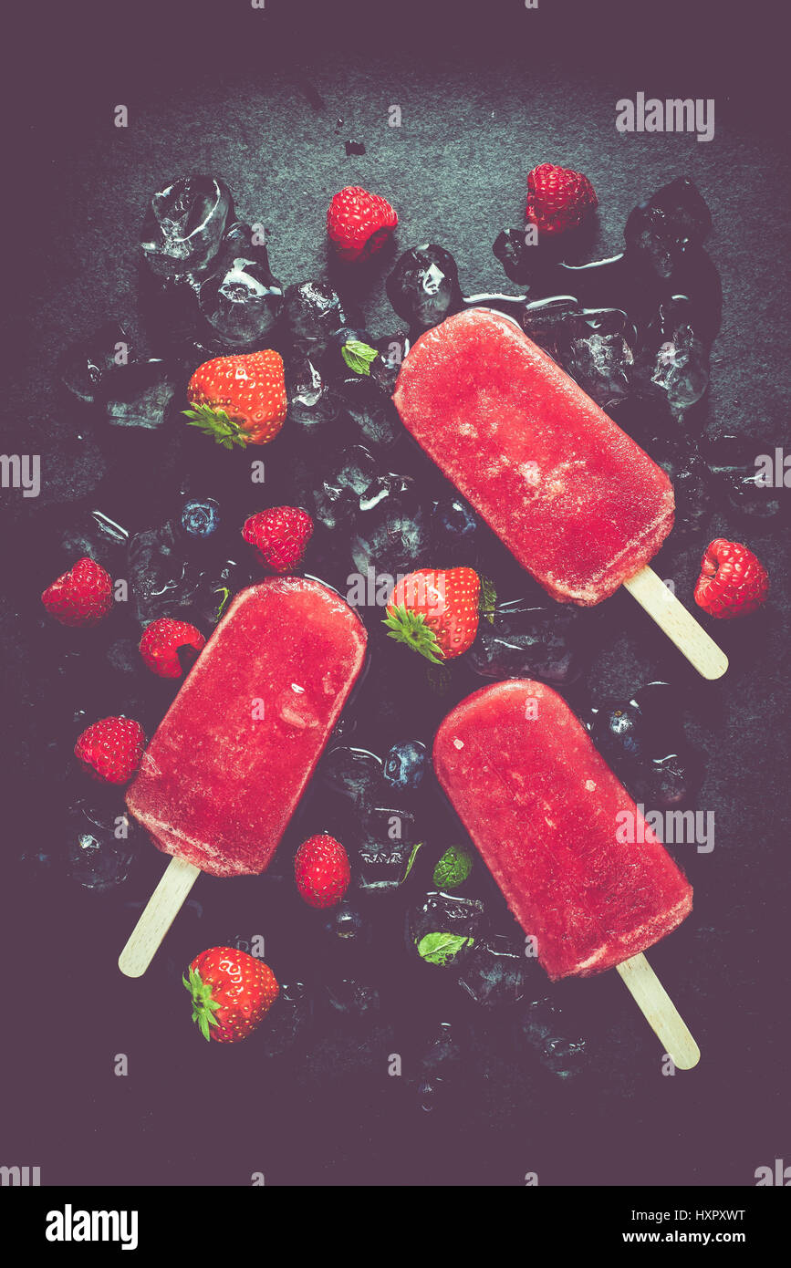 Refreshing popsicle on ice cubes and fruits, food background Stock ...