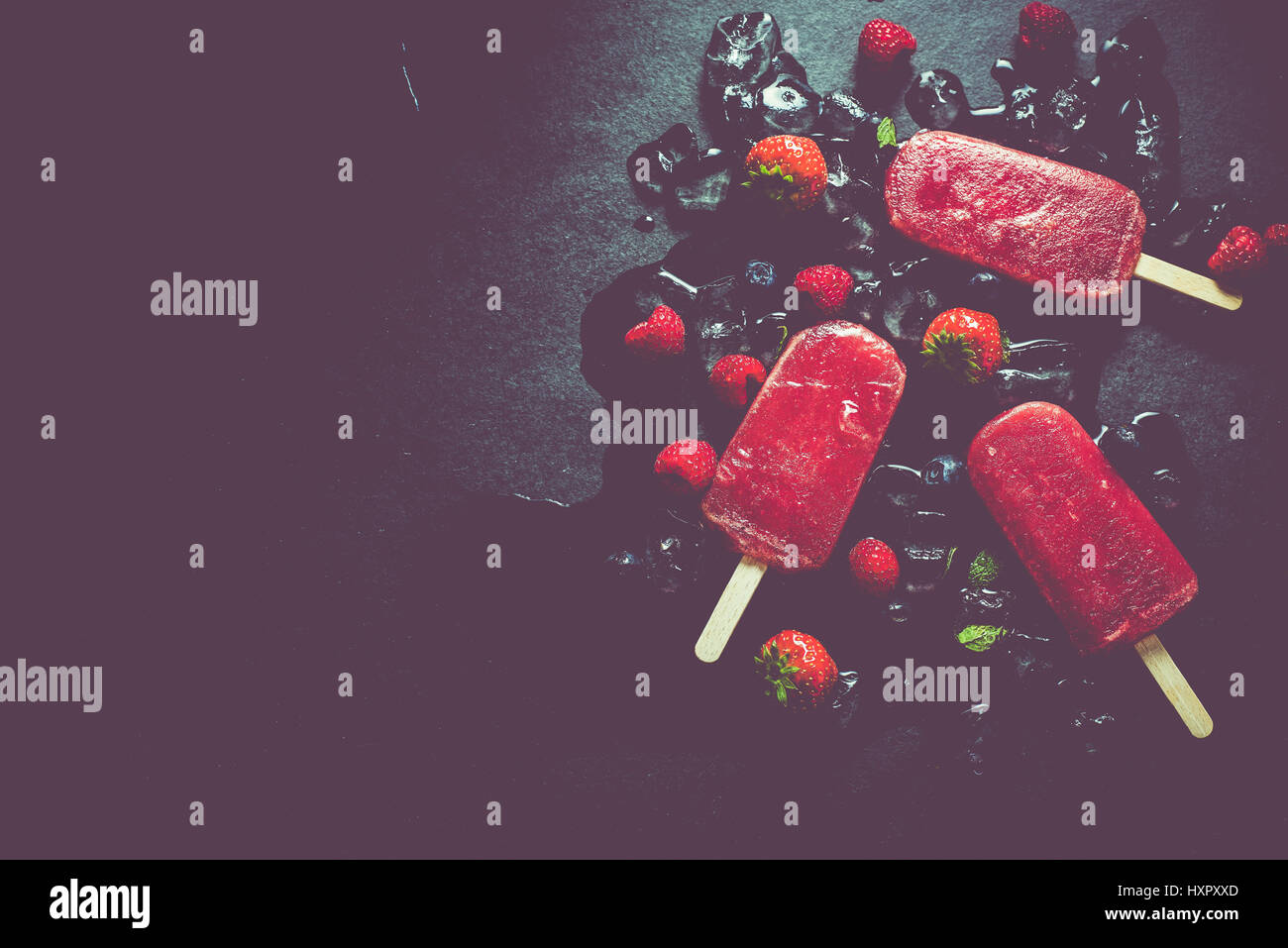 Refreshing popsicle on ice cubes and fruits, food background Stock ...