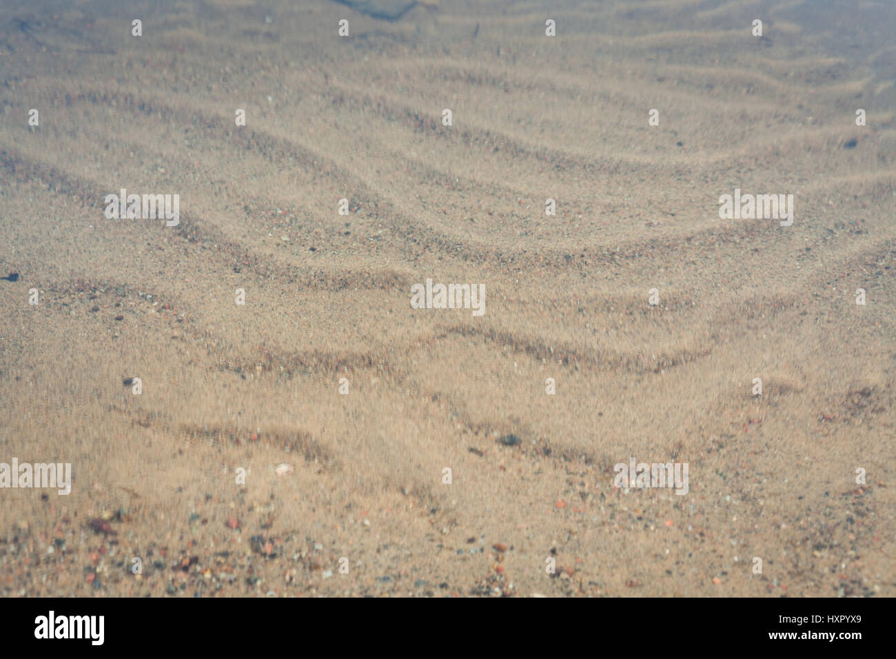 Sand shaped by waves underwater Stock Photo - Alamy