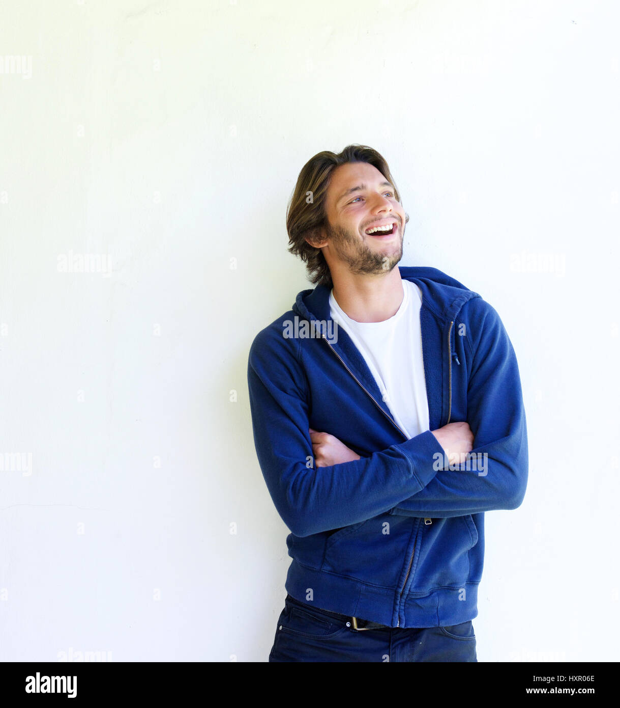 Portrait of laughing young man looking up Stock Photo - Alamy