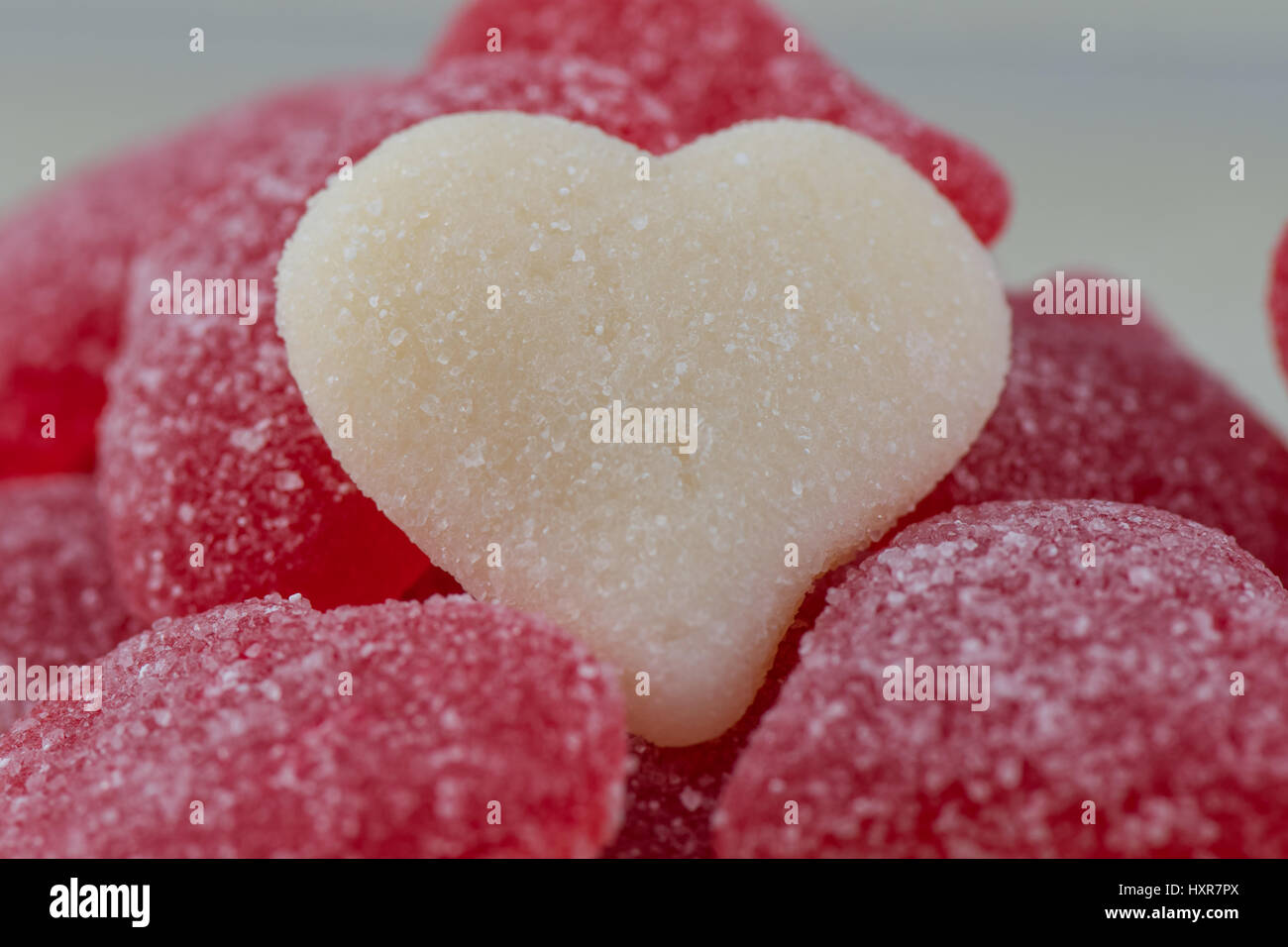 White Gummy Heart of Pile of Red Gummy Hearts detail Stock Photo - Alamy