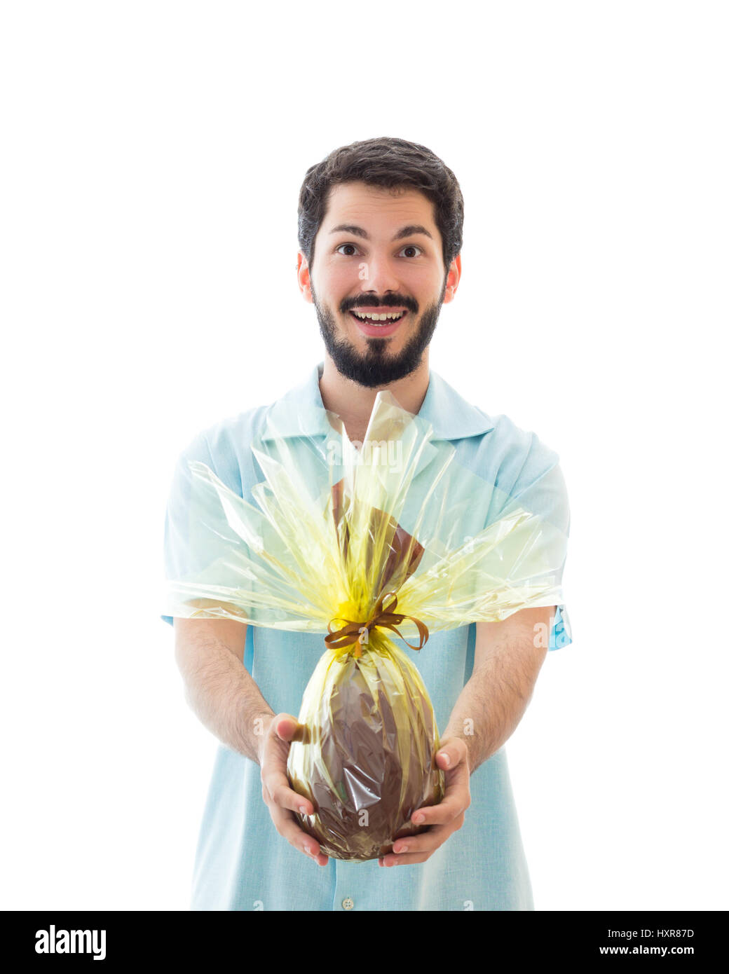 Cheerful man hands out chocolate in the form of Easter egg. Celebrating ...