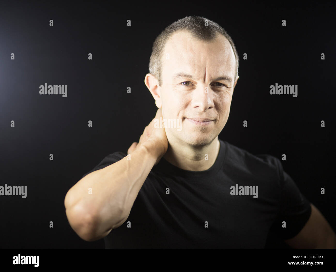 Attractive handsome slim healthy man aged in 40's in black t-shirt ...