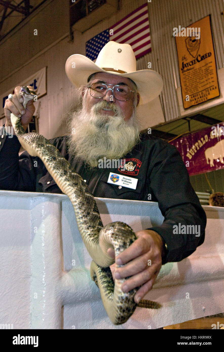 Donnie Willman, a Jaycee volunteer snake handler holds a western ...