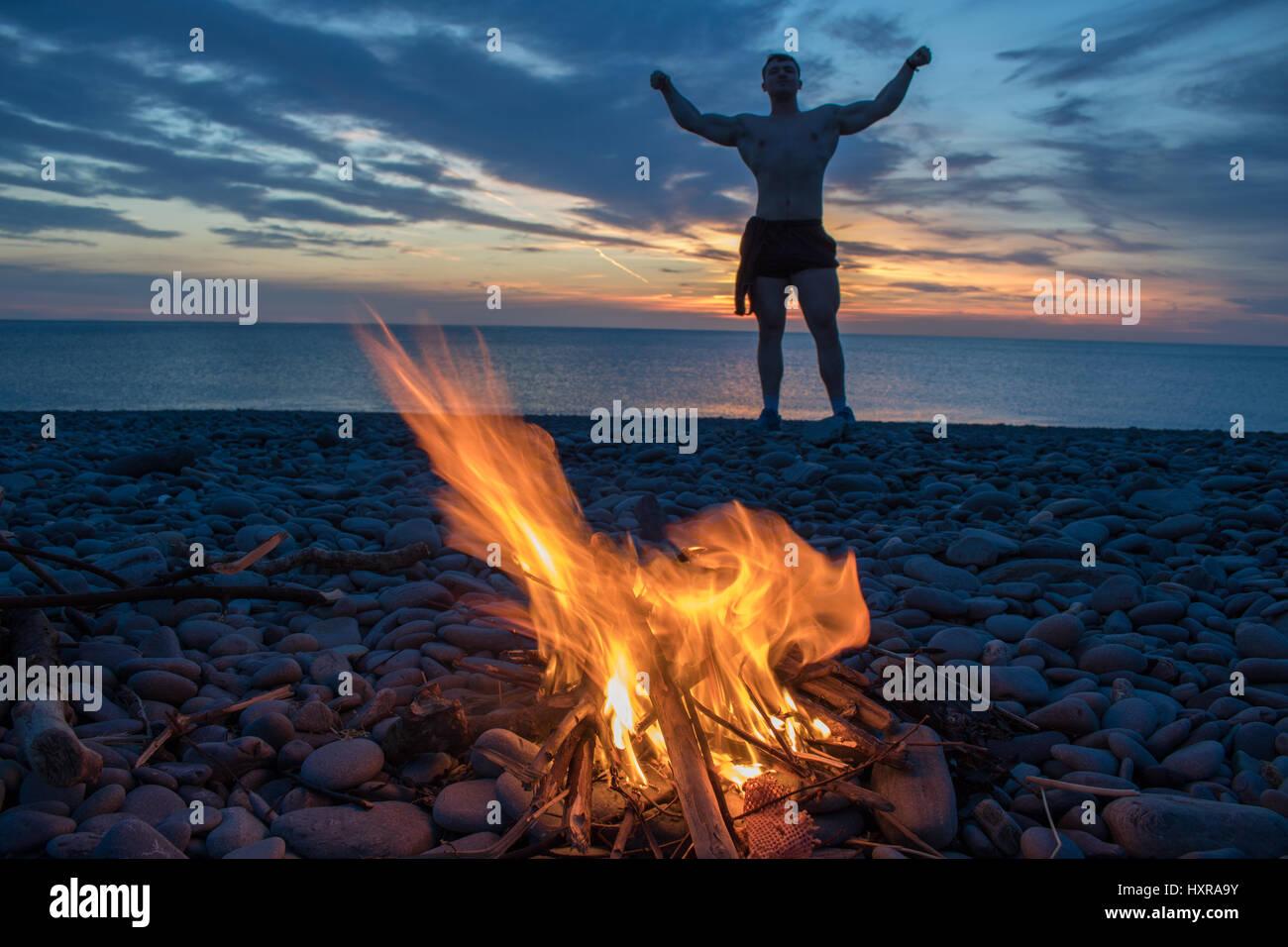 Fire at sunset Stock Photo - Alamy