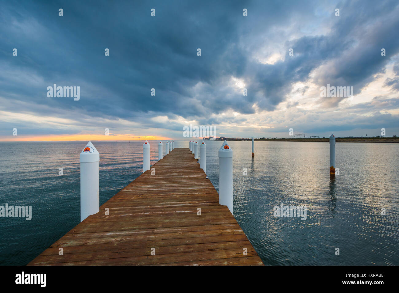 Dramatic sunset over a pier in the Chesapeake Bay, in Kent Island ...