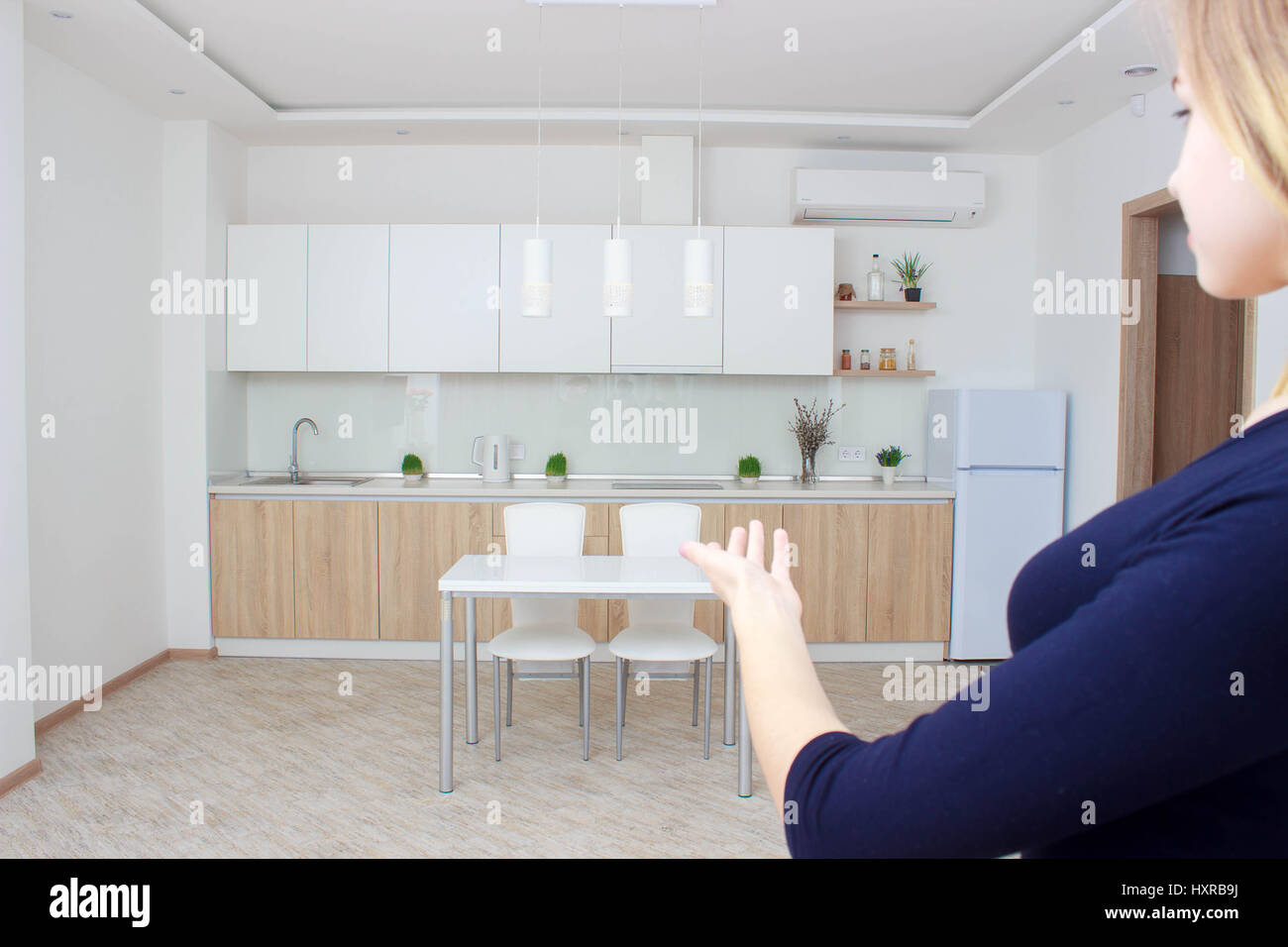 Real estate agent presenting modern house to client, woman Shows the ...