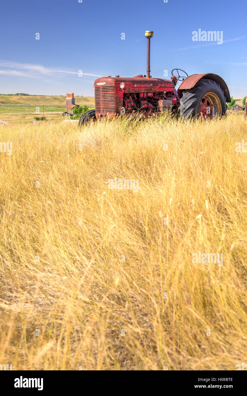 Old abandoned farm tractor in a field hi-res stock photography and ...