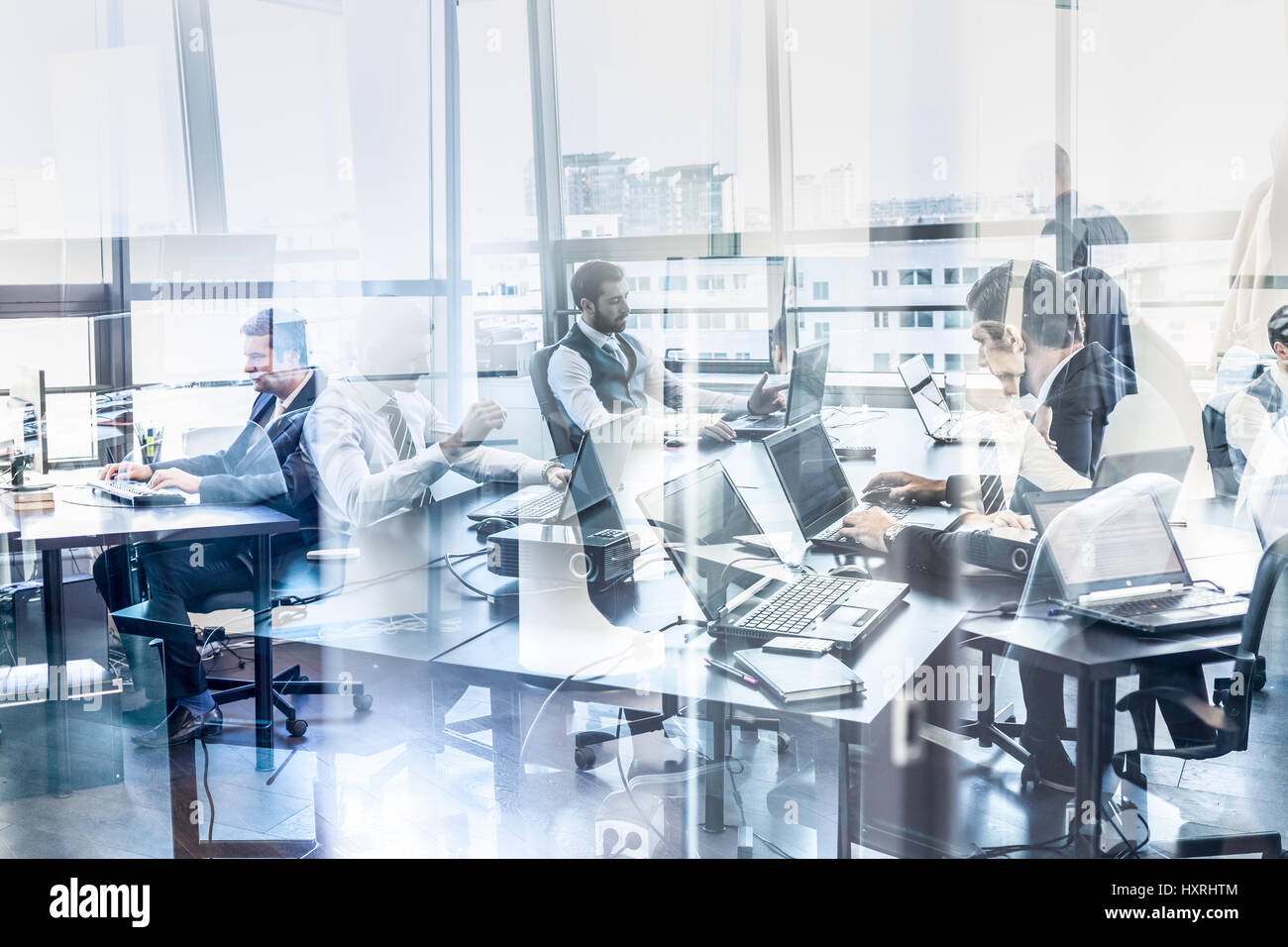 Workplace in modern corporate office with business people working on ...