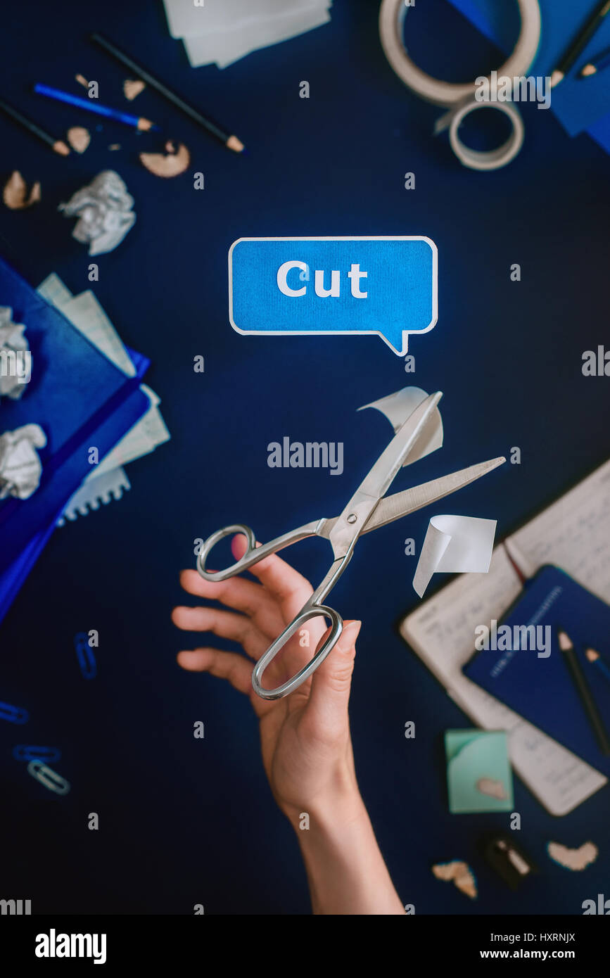 Office desk with paper context menu saying: Cut. Overhead shot in a low ...