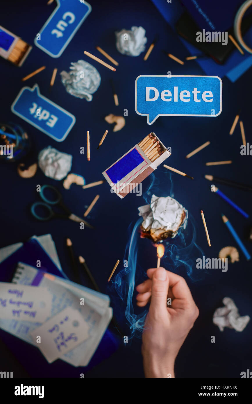 Working place with paper context menu saying: Delete. Still life with ...