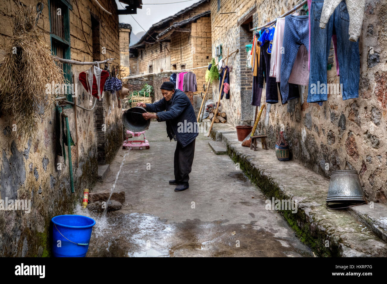 Chinese man water bucket hi-res stock photography and images - Alamy