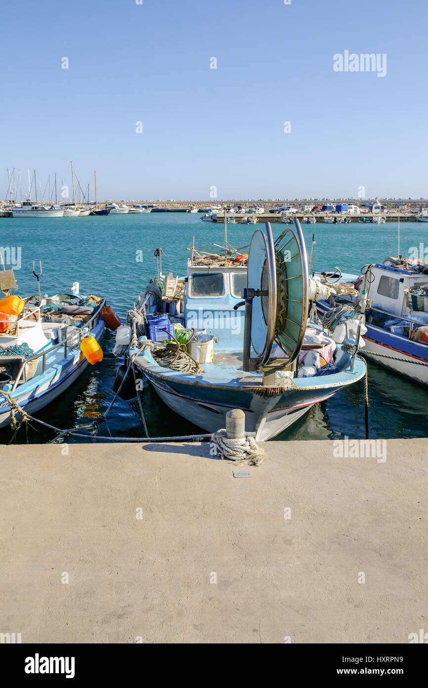 Fishing boat moored at Zygi, Cyprus, afternoon shot with blue sky Stock ...