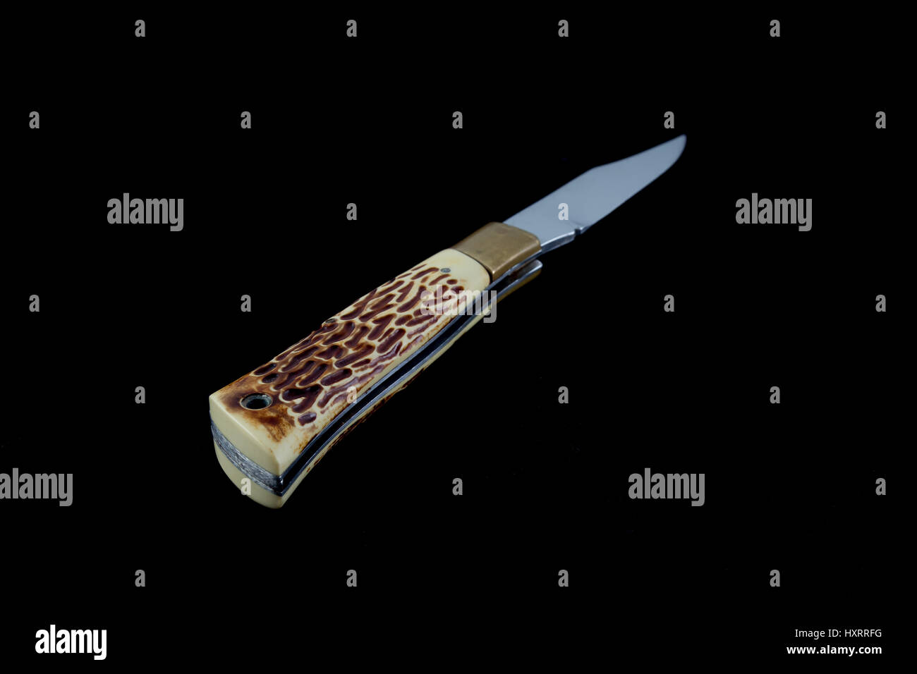 Back of a vintage pocketknife with horn handle and brass guard - black ...