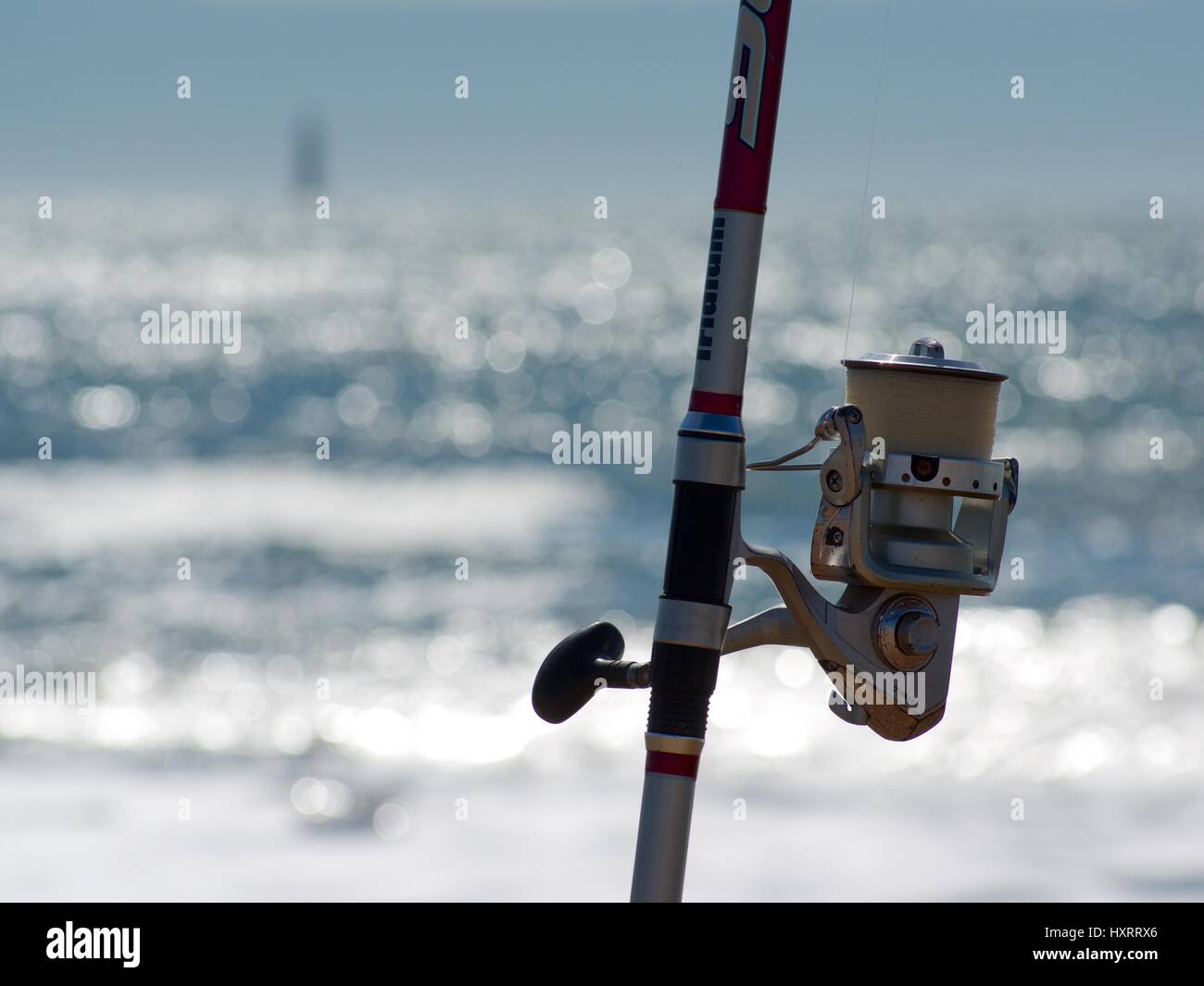 Close up of fishing rod and reel at beach near Sables d'Olonne, France ...