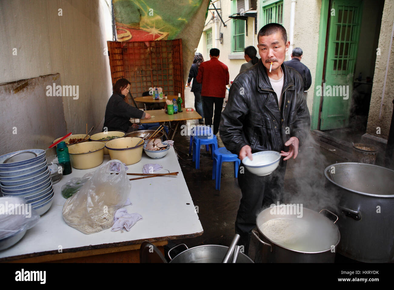 Shanghai, China - April 20, 2010: Cheap sidewalk eatery in a narrow ...