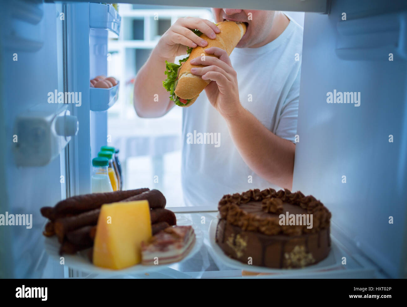 Overweight man on diet break diet with big sandwich roll Stock Photo ...