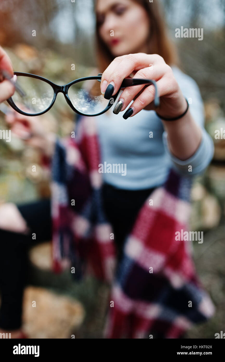 Girl gives her friend glasses, soft focus. Bad eye vision of people ...